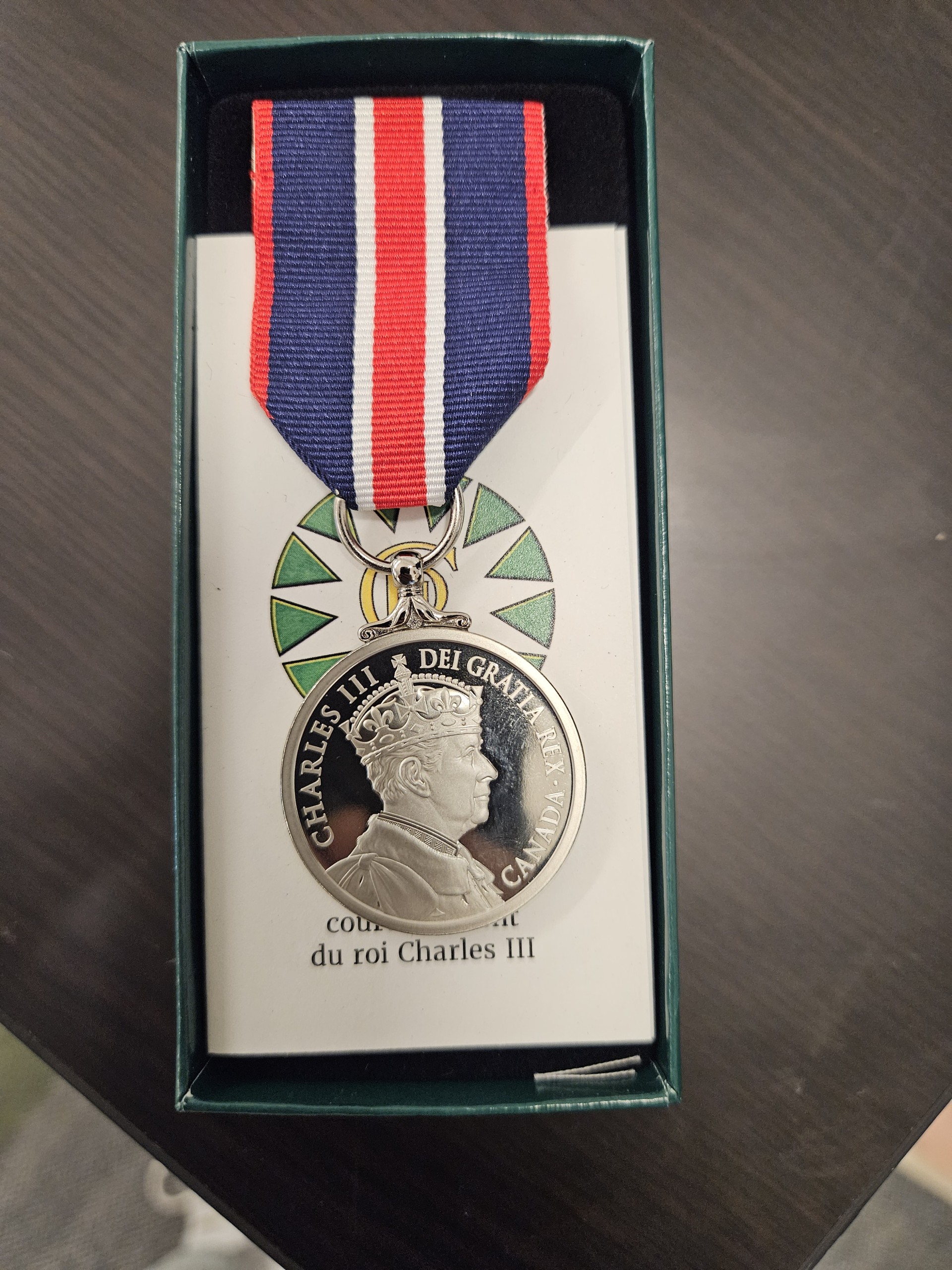 Sun Peaks mayor Al Raine accepts a King Charles III Coronation Medal